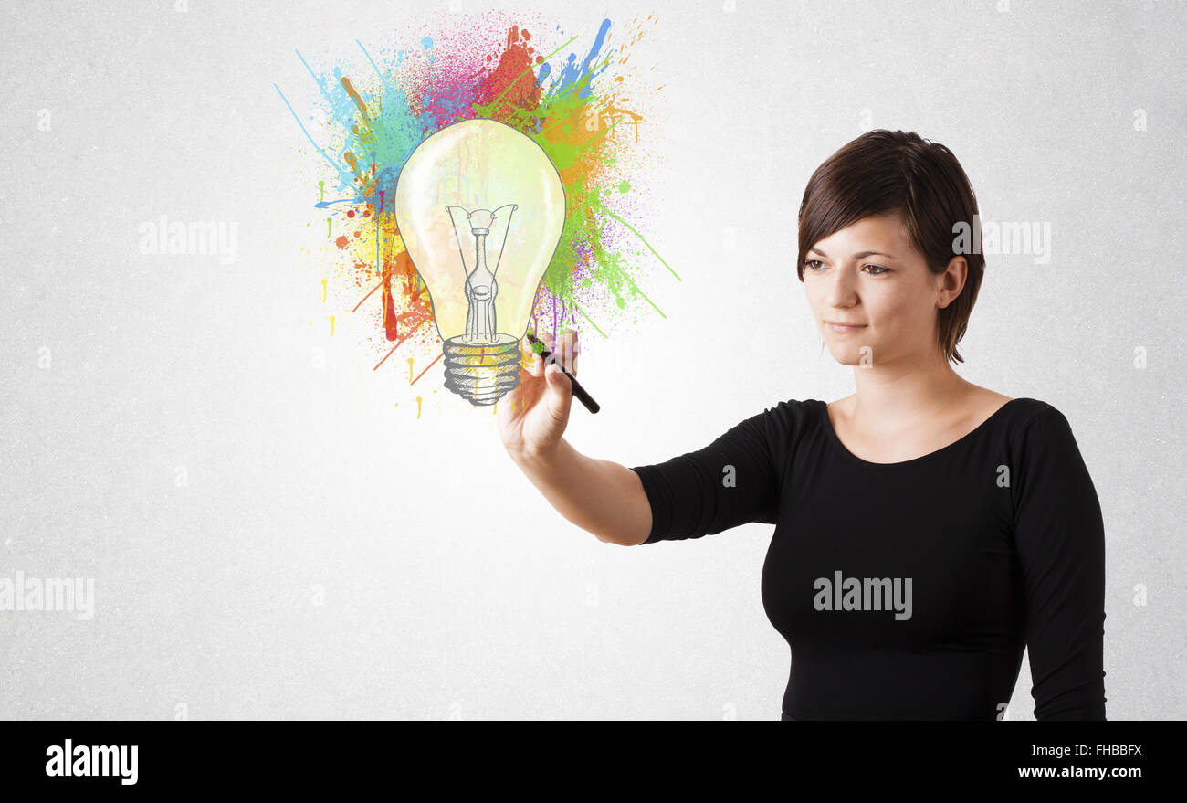 Young lady drawing a colorful light bulb with colorful splashes Stock ...