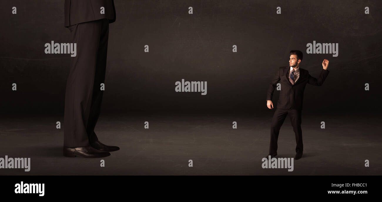 Huge man with small businessman standing at front concept Stock Photo ...