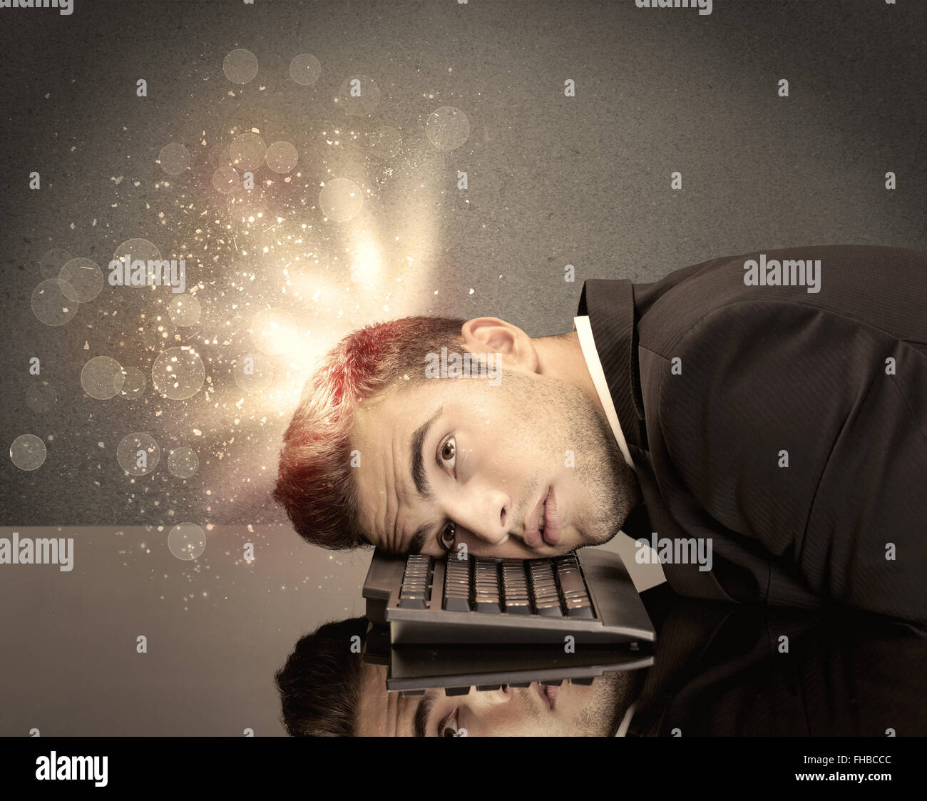 Angry businessman with lights and keyboard Stock Photo - Alamy