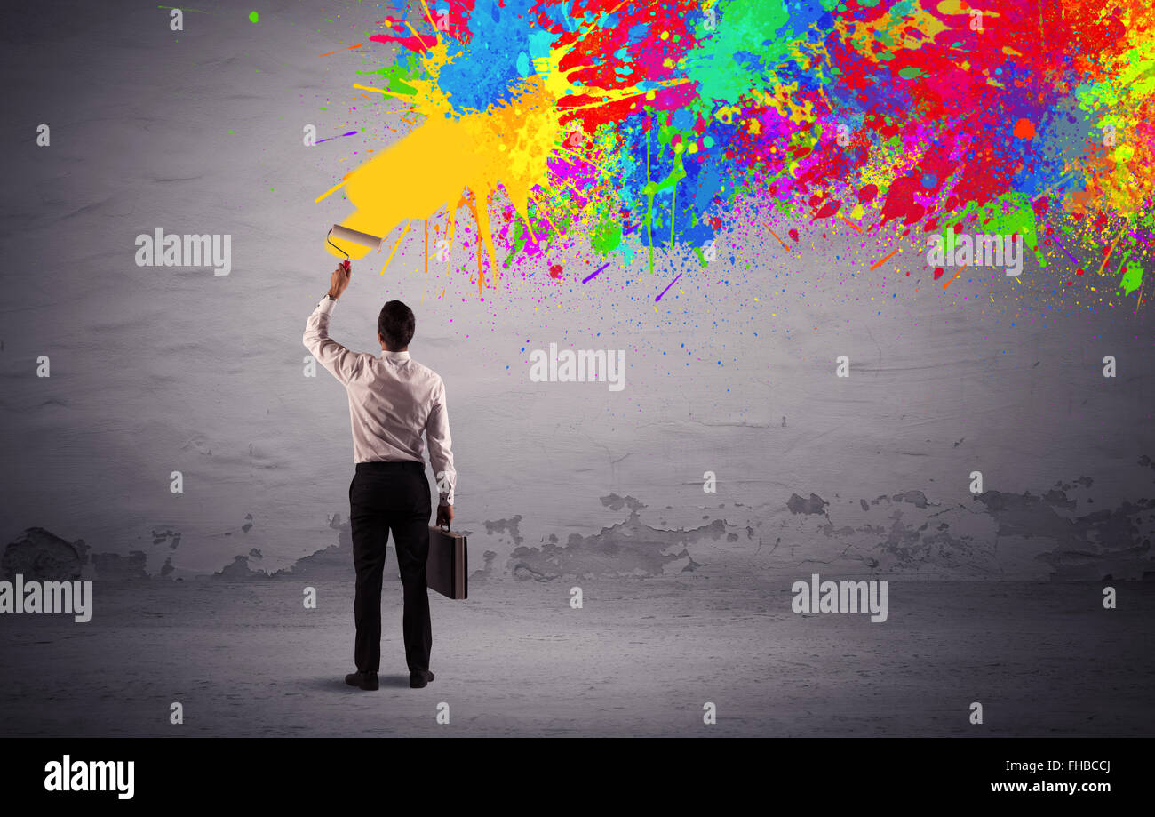 Sales person painting colorful splatter Stock Photo - Alamy