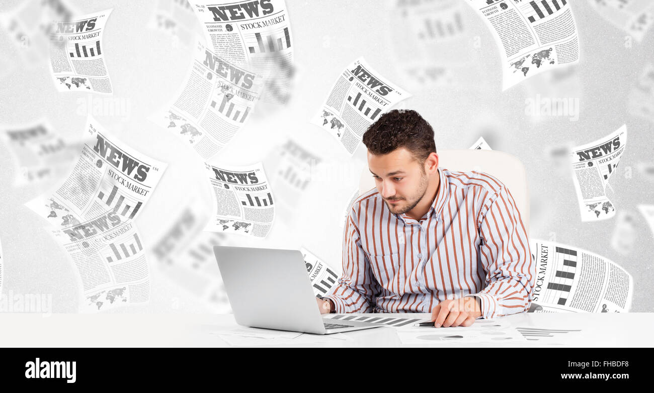 Business man at desk with stock market newspapers Stock Photo - Alamy