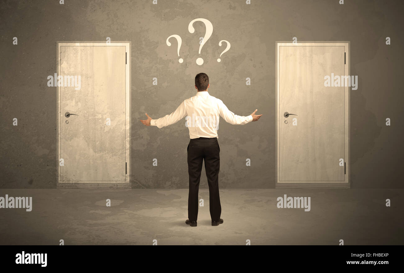 Confused businessman choosing right door hi-res stock photography and ...