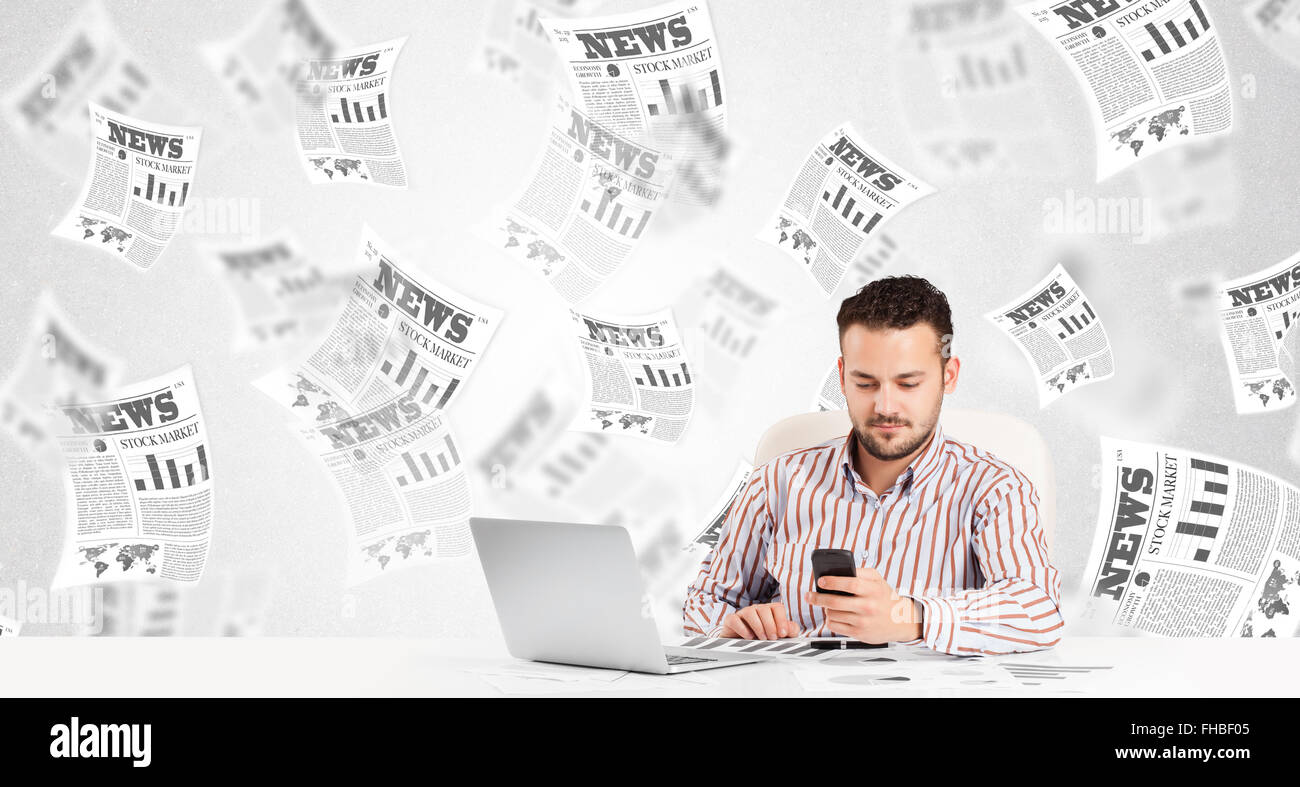 Business man at desk with stock market newspapers Stock Photo - Alamy