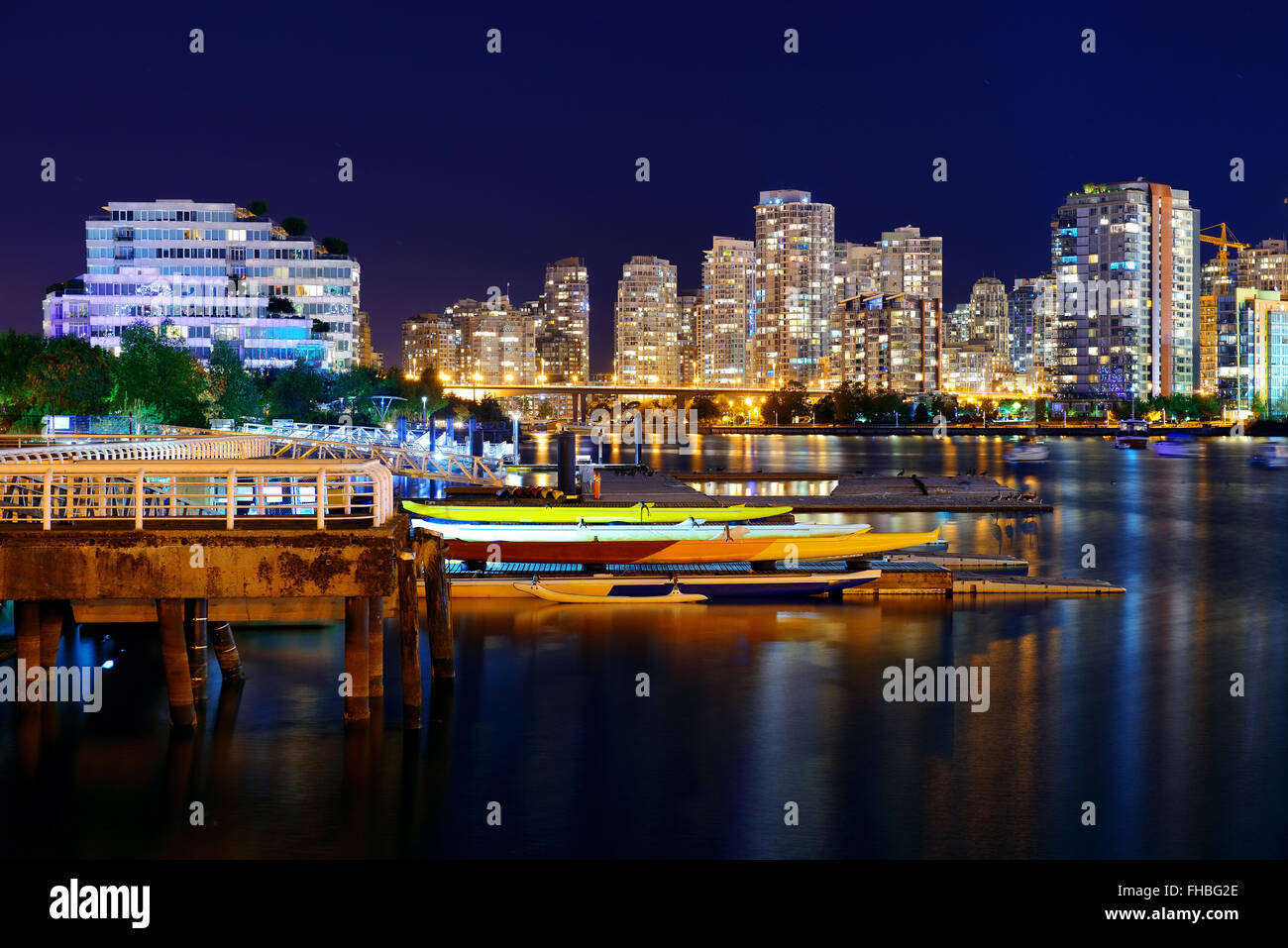 Vancouver city night view with buildings and boat in bay Stock Photo ...