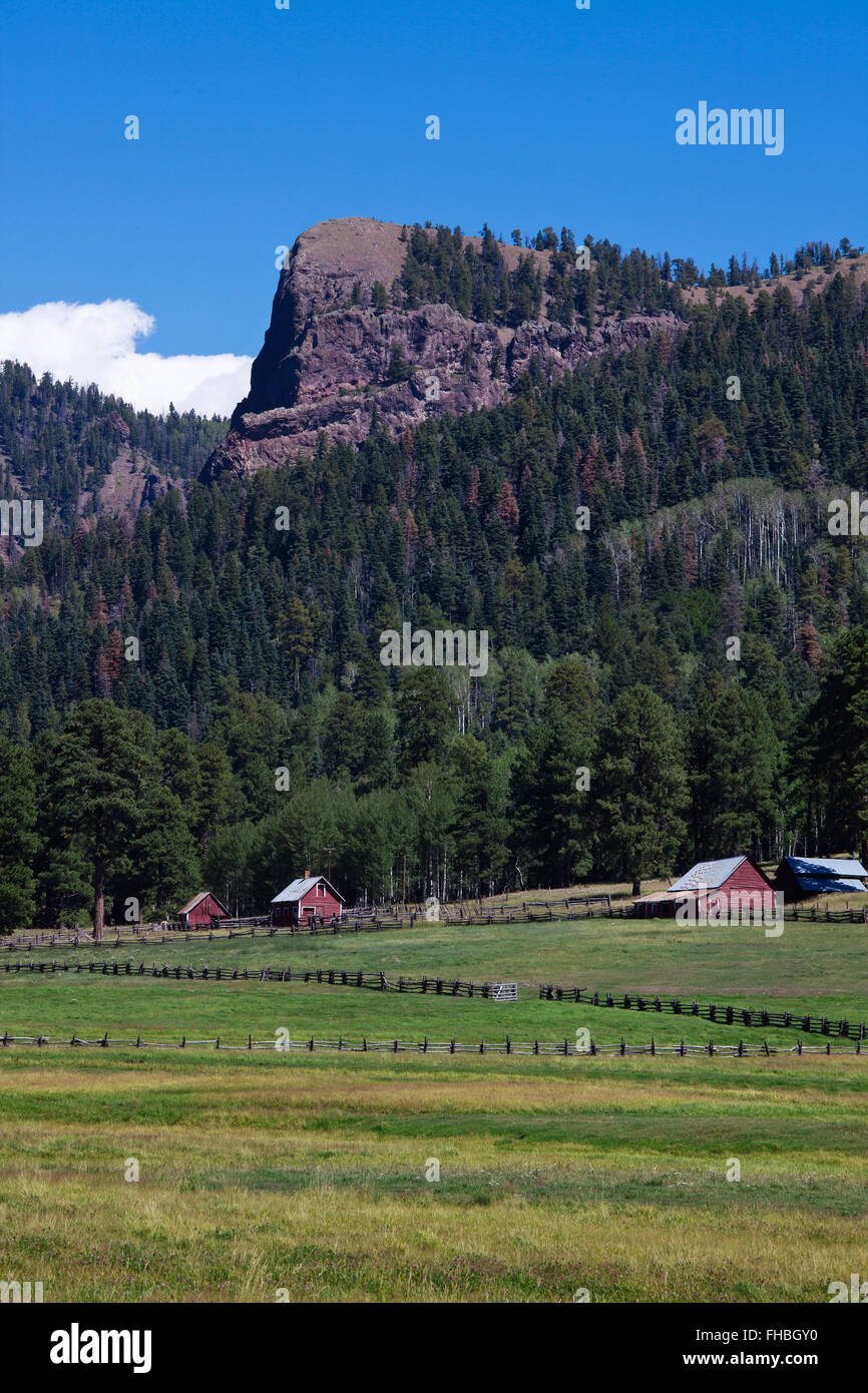 A ranch sits below volcanic peaks in ROCKY MOUNTAINS - SOUTHERN ...