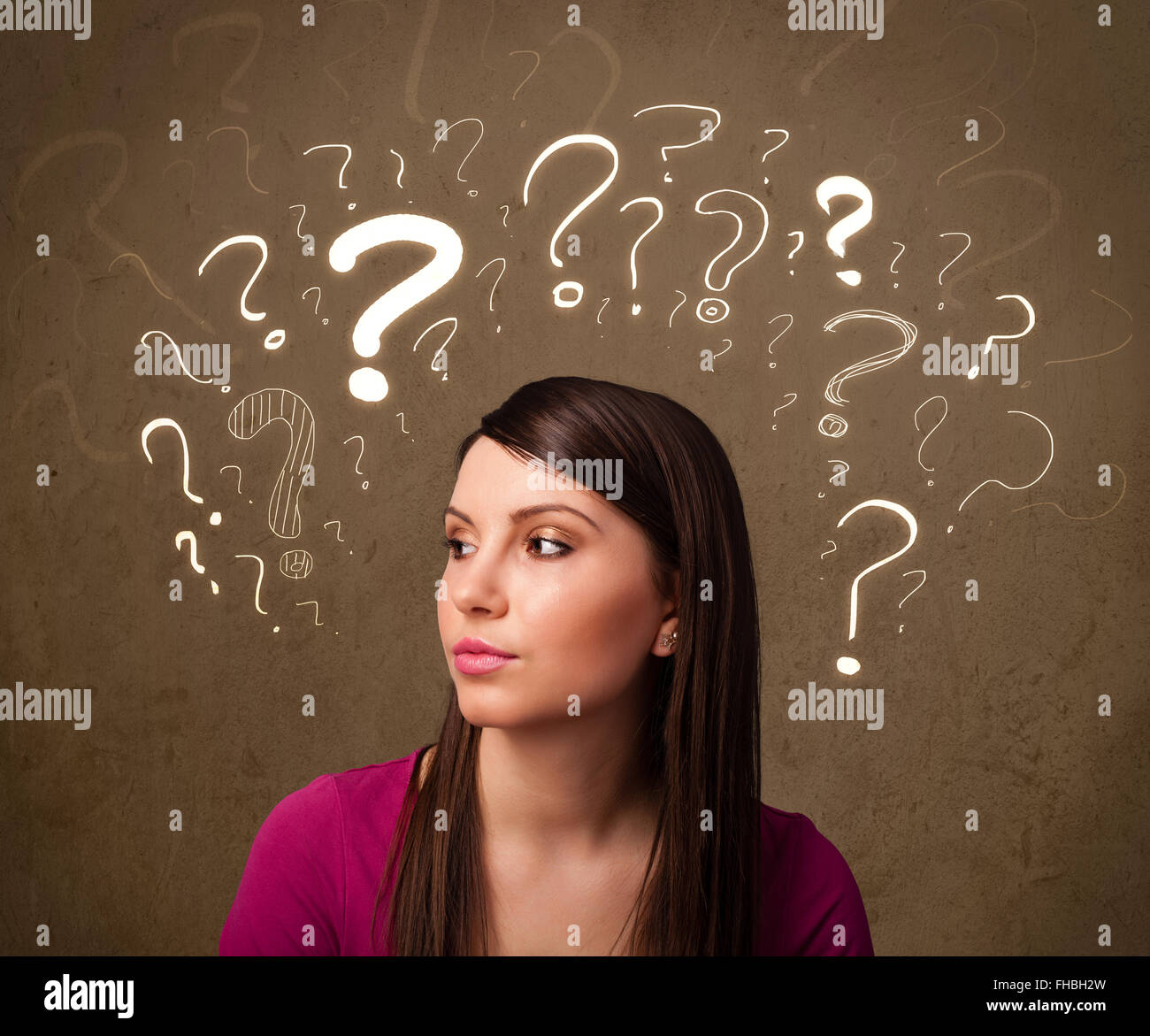girl with question mark symbols around her head Stock Photo - Alamy