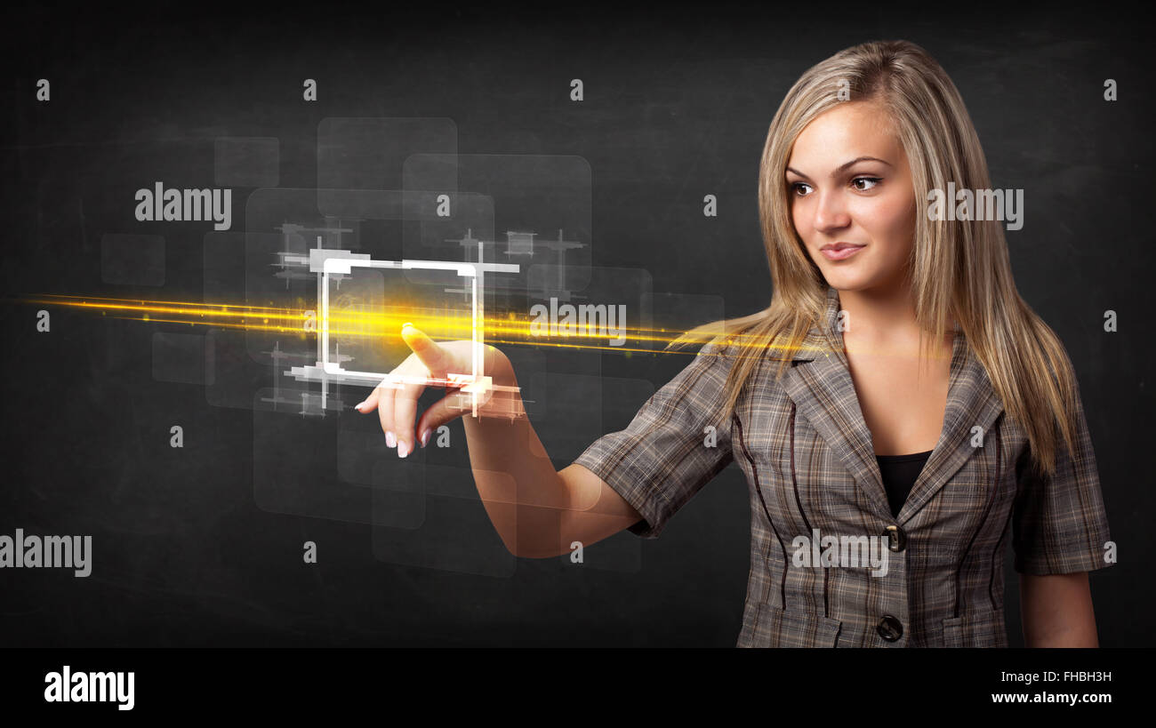 Young tech lady touching button with orange light beams concept Stock ...