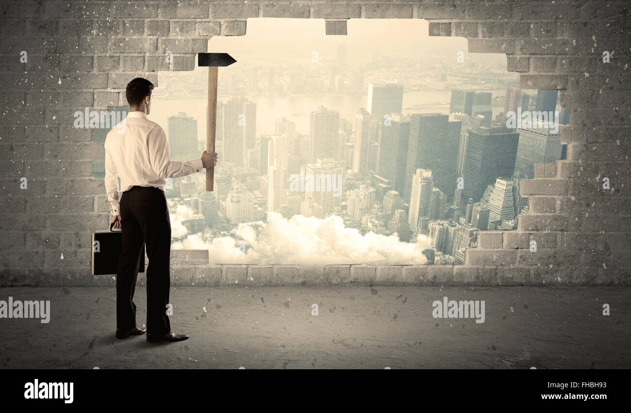 Business man hitting wall with hammer on city view Stock Photo - Alamy