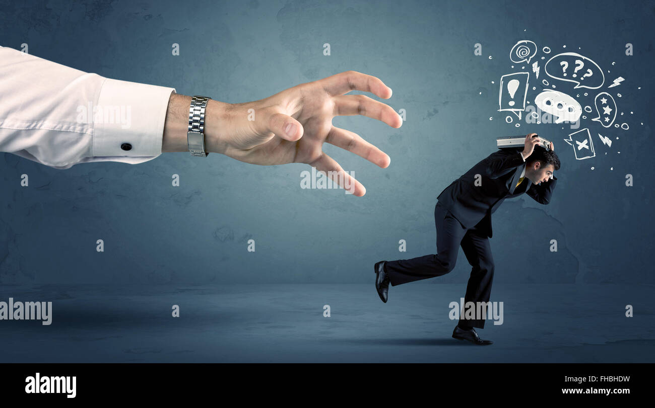 Business man running from a big hand Stock Photo - Alamy