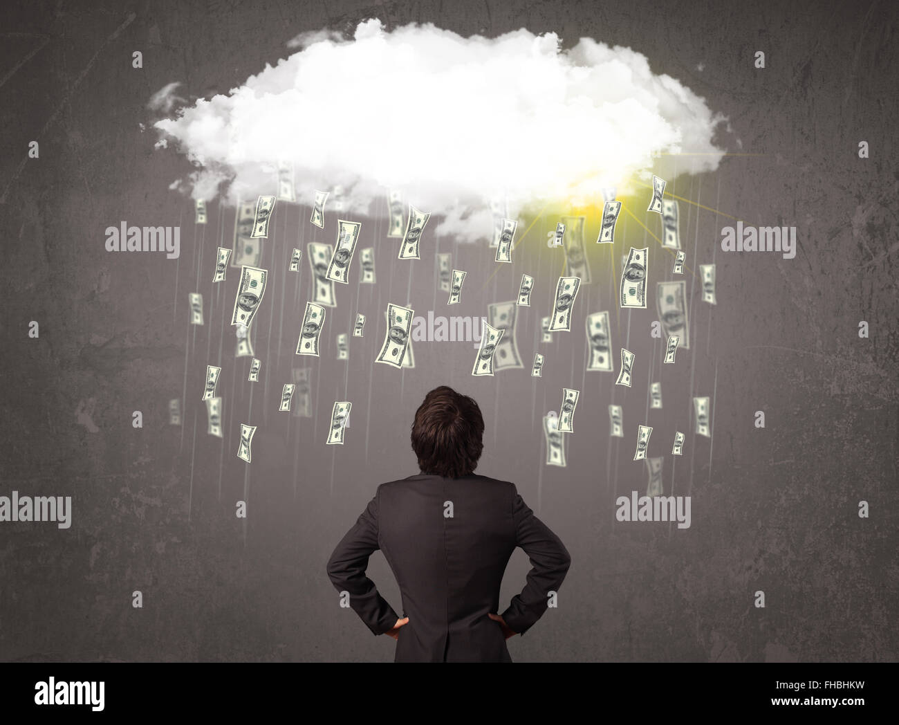 Business man in suit looking at cloud with falling money Stock Photo ...