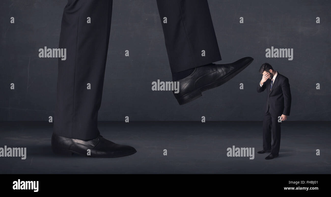 Giant person stepping on a little businessman concept Stock Photo - Alamy