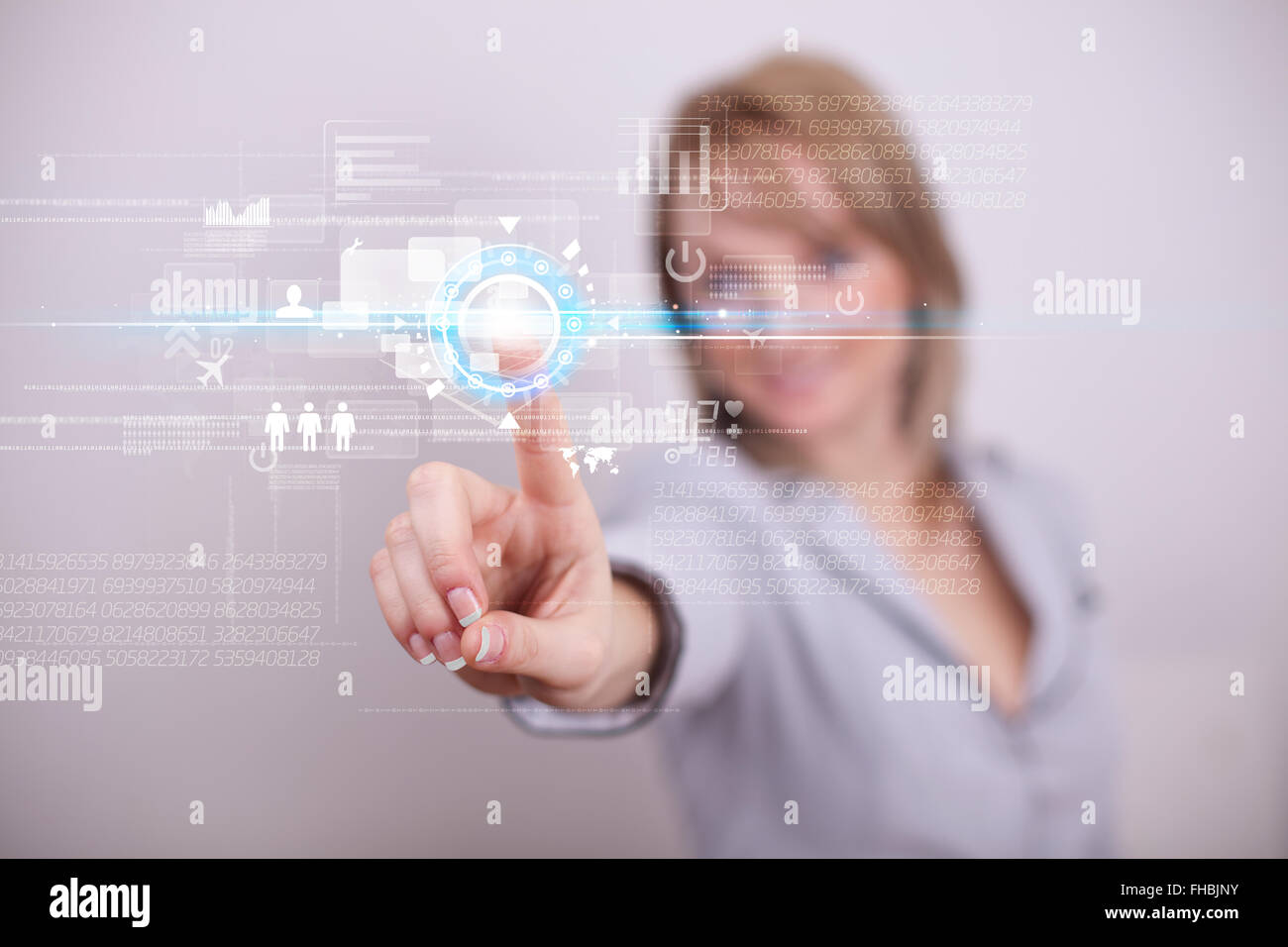 Young business woman touching future web technology buttons and icons ...