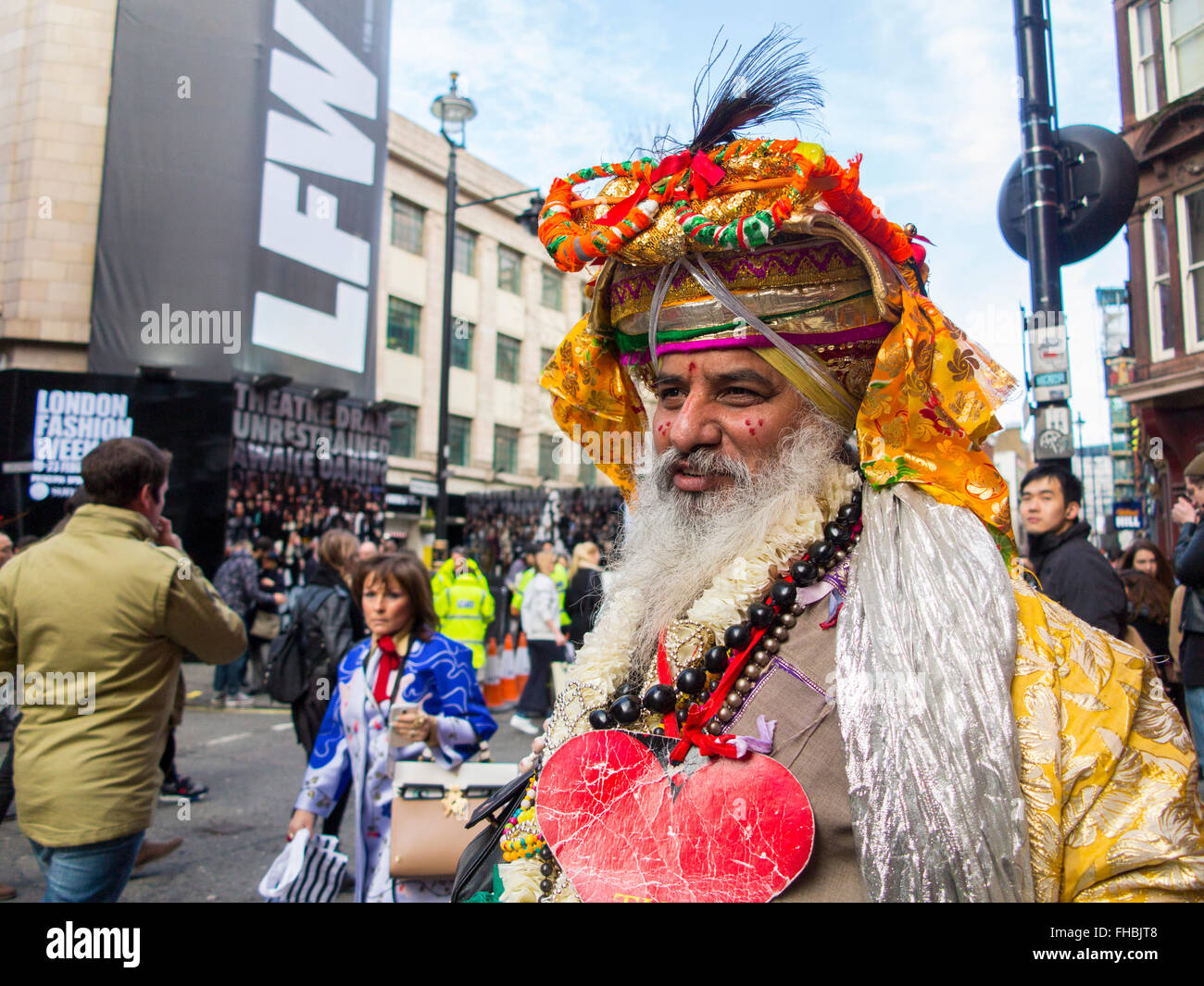 An Indian man in brightly coloured clothes at the London Fashion Week ...