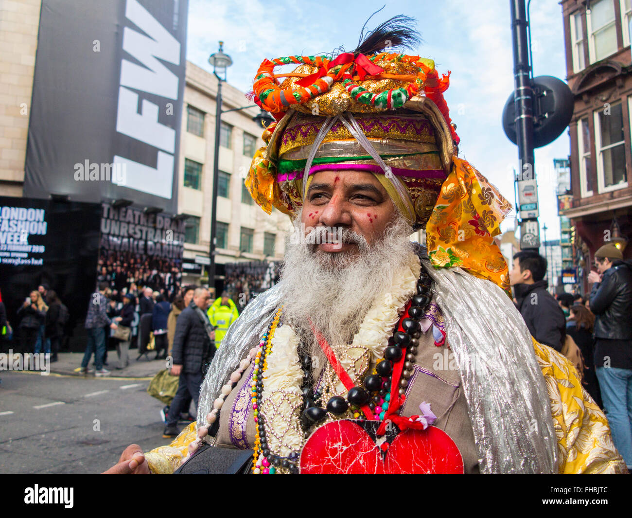 An Indian man in brightly coloured clothes at the London Fashion Week ...