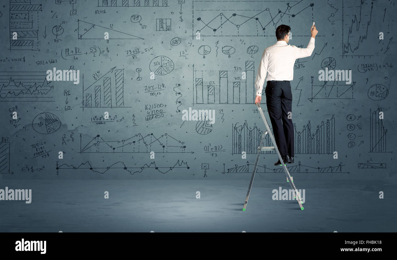 Man on ladder drawing charts Stock Photo - Alamy