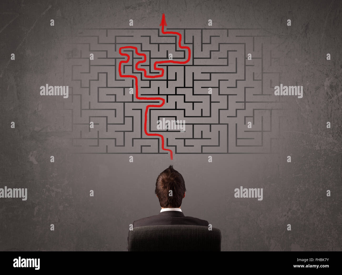 Business man looking at a maze and the way out Stock Photo - Alamy