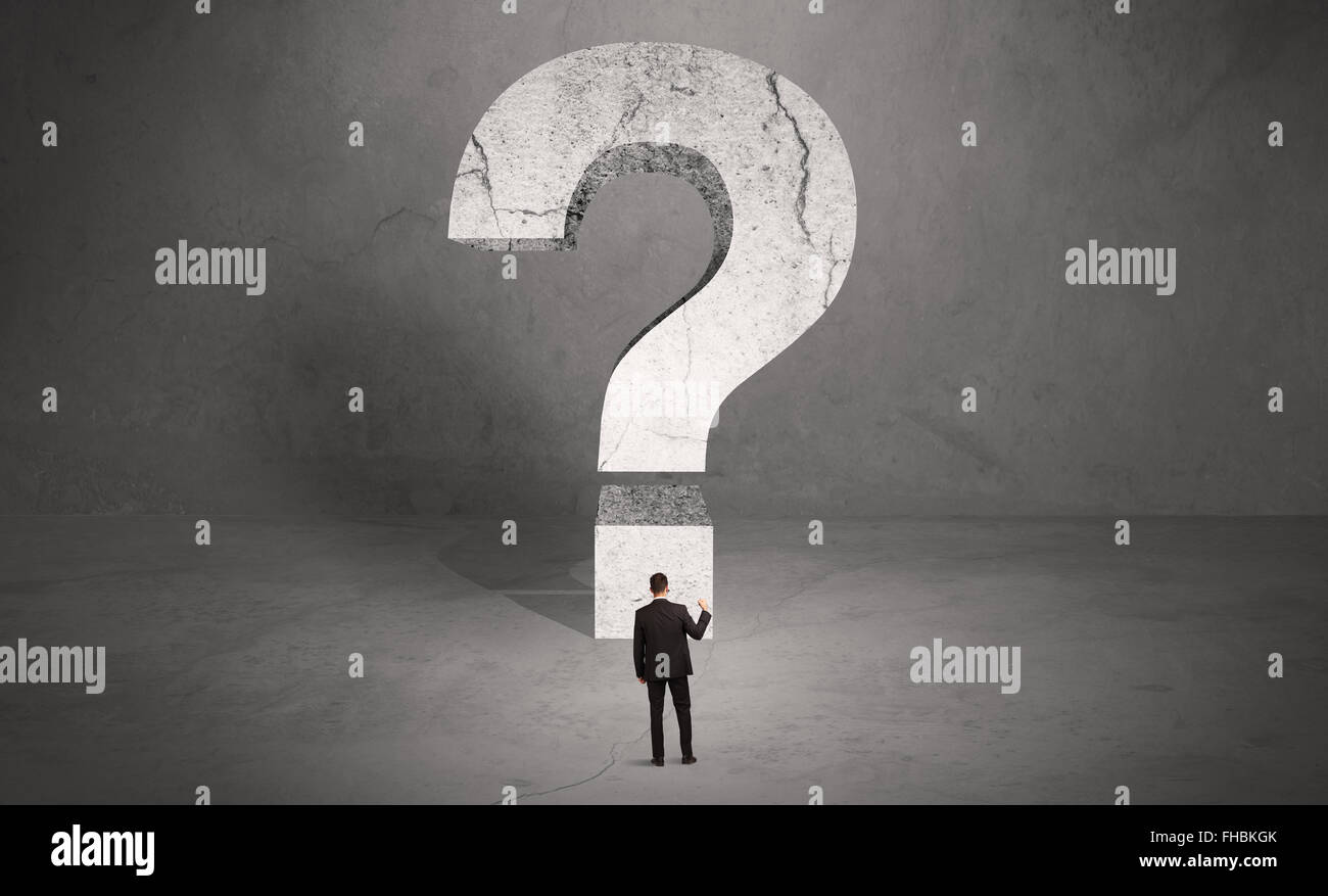 Confused businessman and big question mark Stock Photo - Alamy