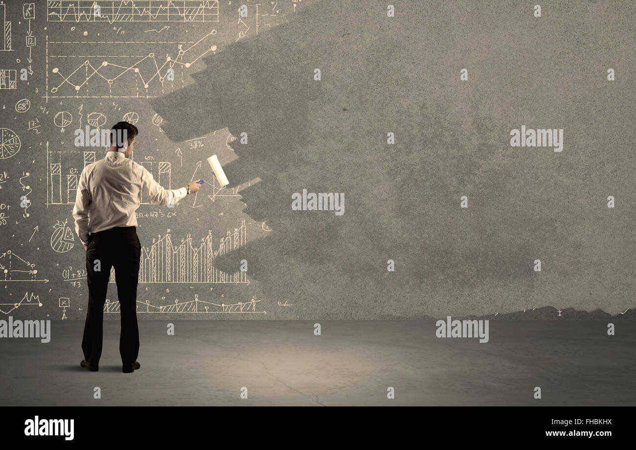 Salesman painting over charts on wall Stock Photo - Alamy