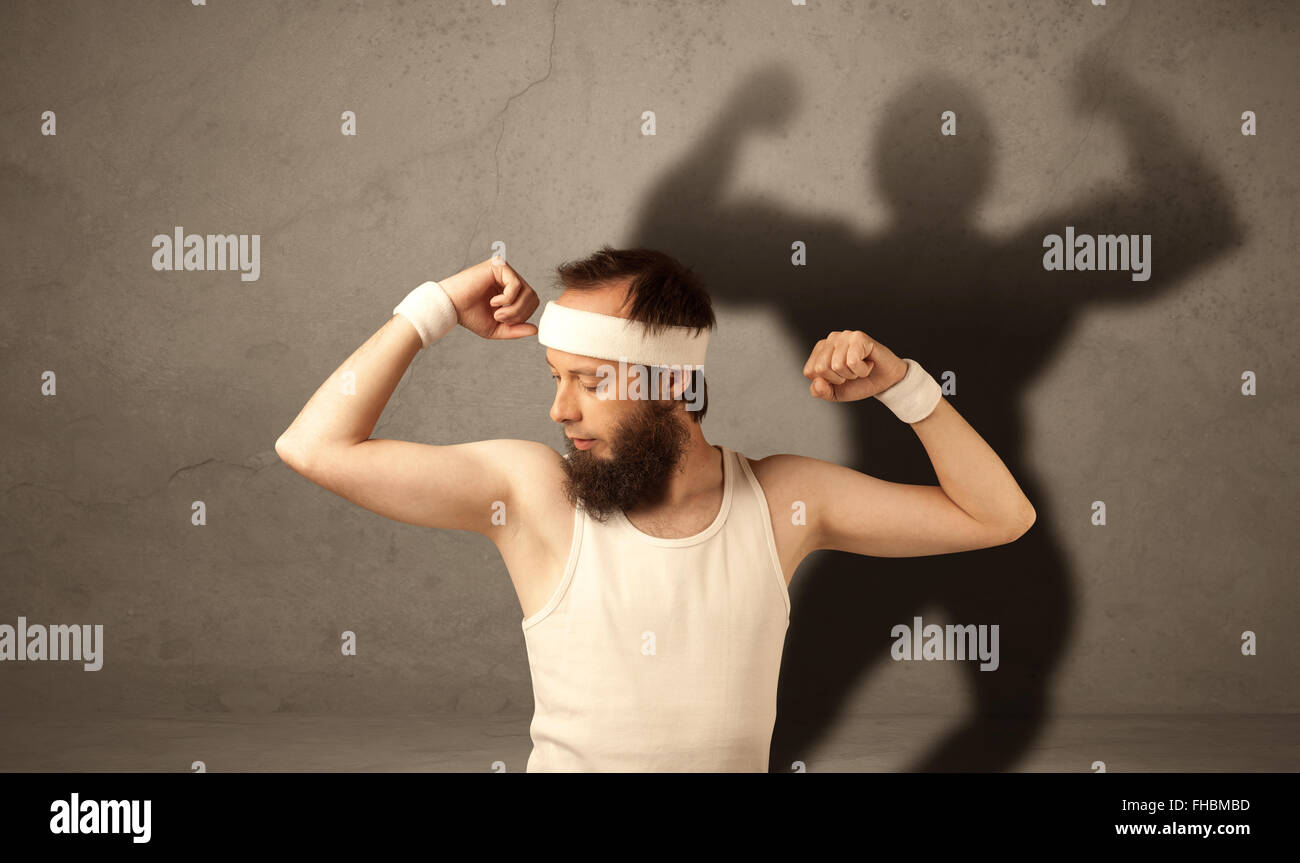 Skinny man with musculous shadow Stock Photo - Alamy