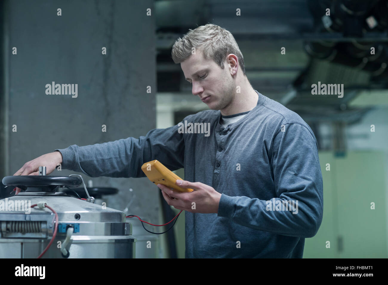 Young man working in technical room Stock Photo - Alamy