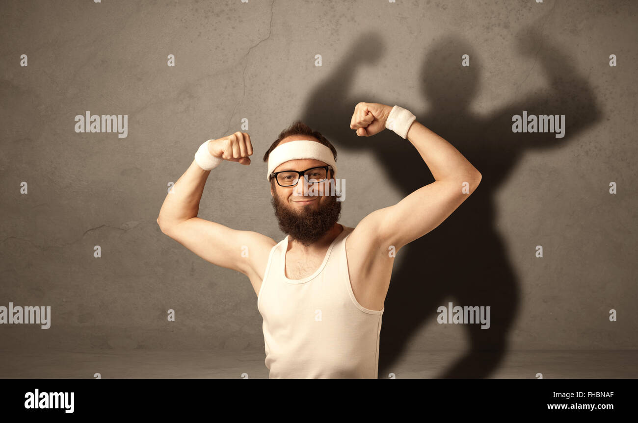 Skinny man with musculous shadow Stock Photo - Alamy