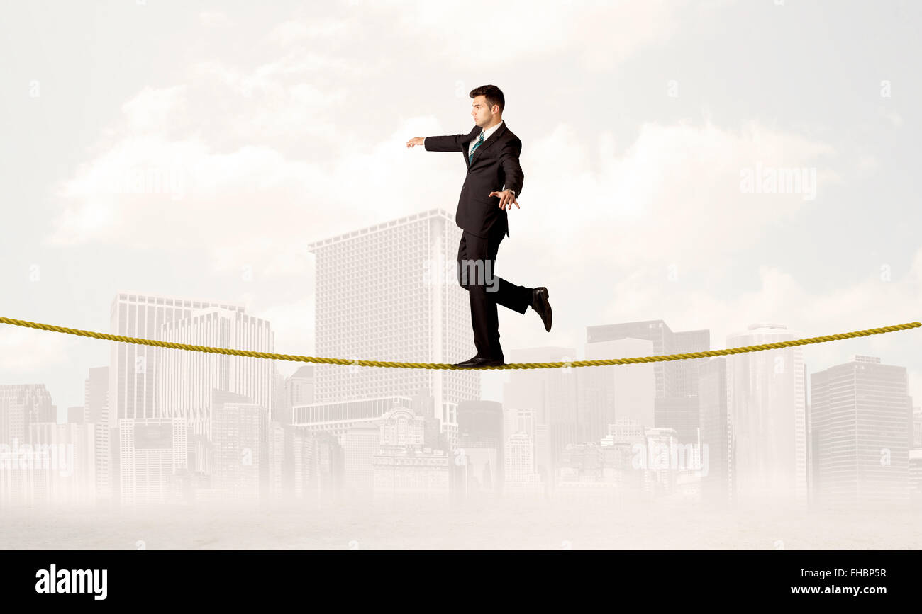 Business person balancing on golden rope Stock Photo - Alamy