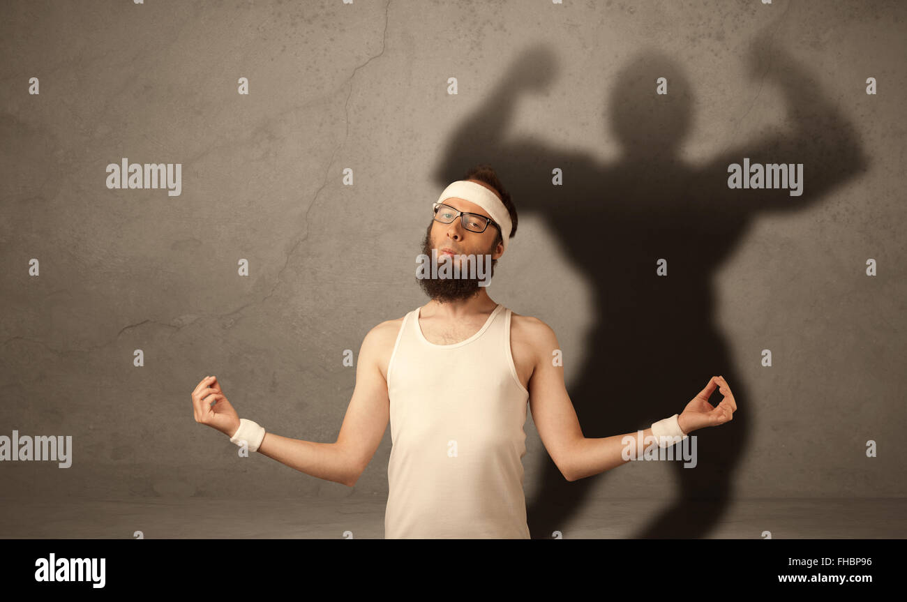 Skinny man with musculous shadow Stock Photo - Alamy