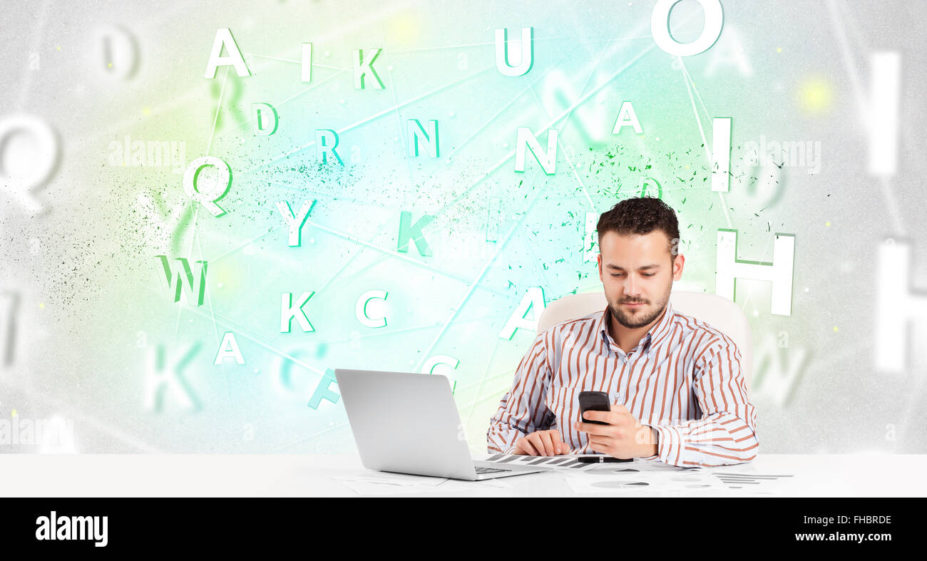 Business man at desk with green word cloud Stock Photo - Alamy