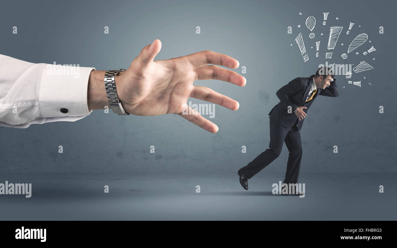 Business person getting away from a big hand Stock Photo - Alamy
