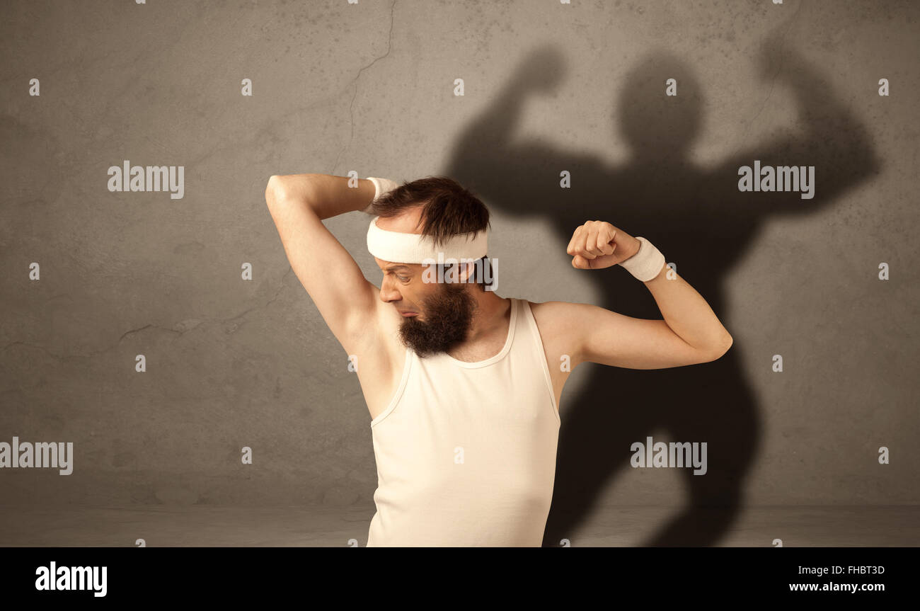 Skinny man with musculous shadow Stock Photo - Alamy