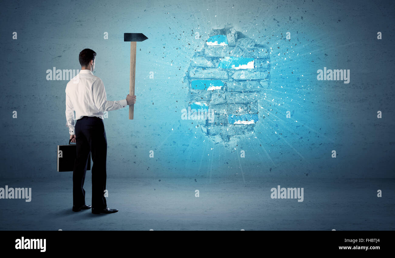 Business man hitting brick wall with huge hammer Stock Photo - Alamy