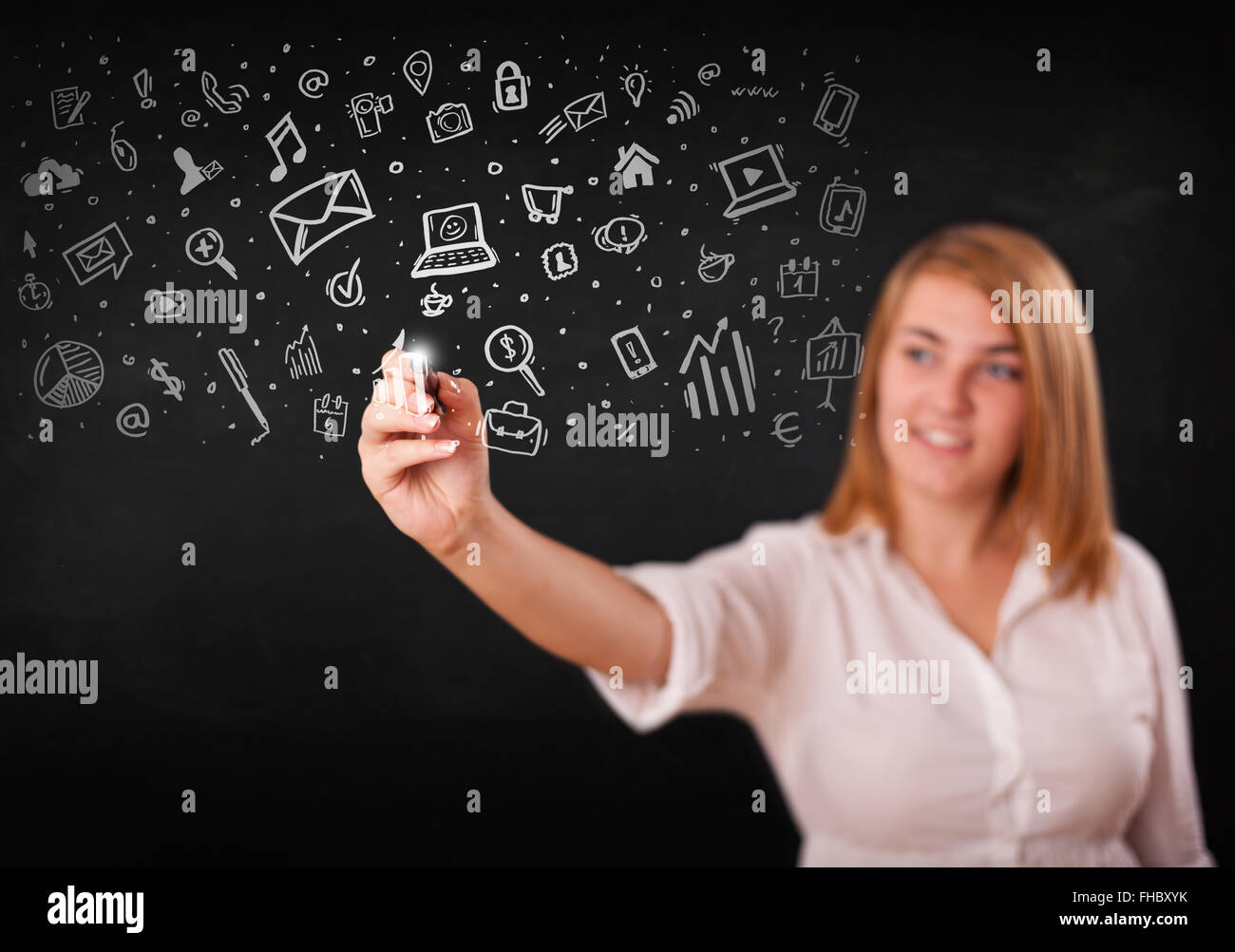 Young woman drawing and sketching icons and symbols Stock Photo - Alamy