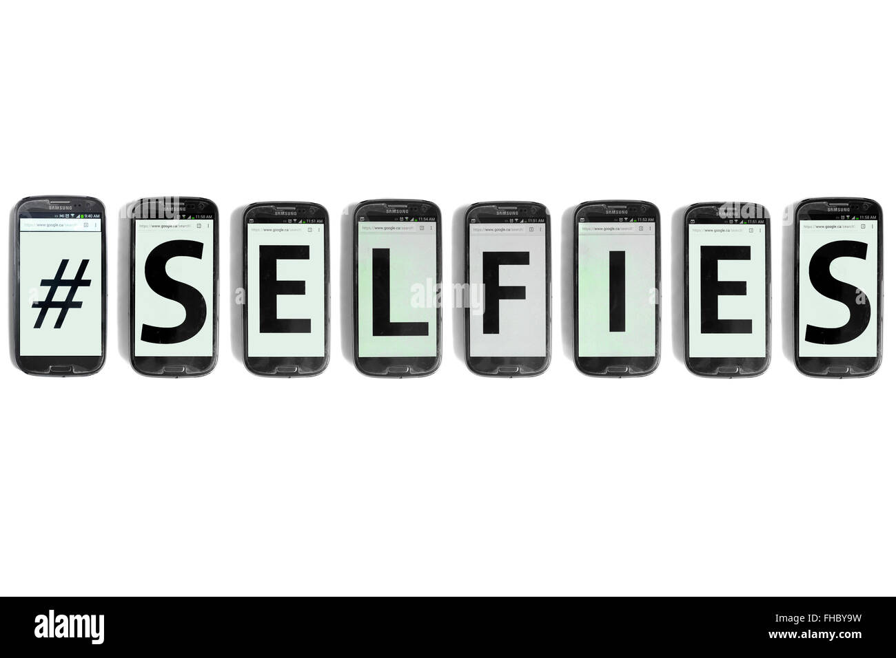 #Selfies written on the screens of smartphones photographed against a ...
