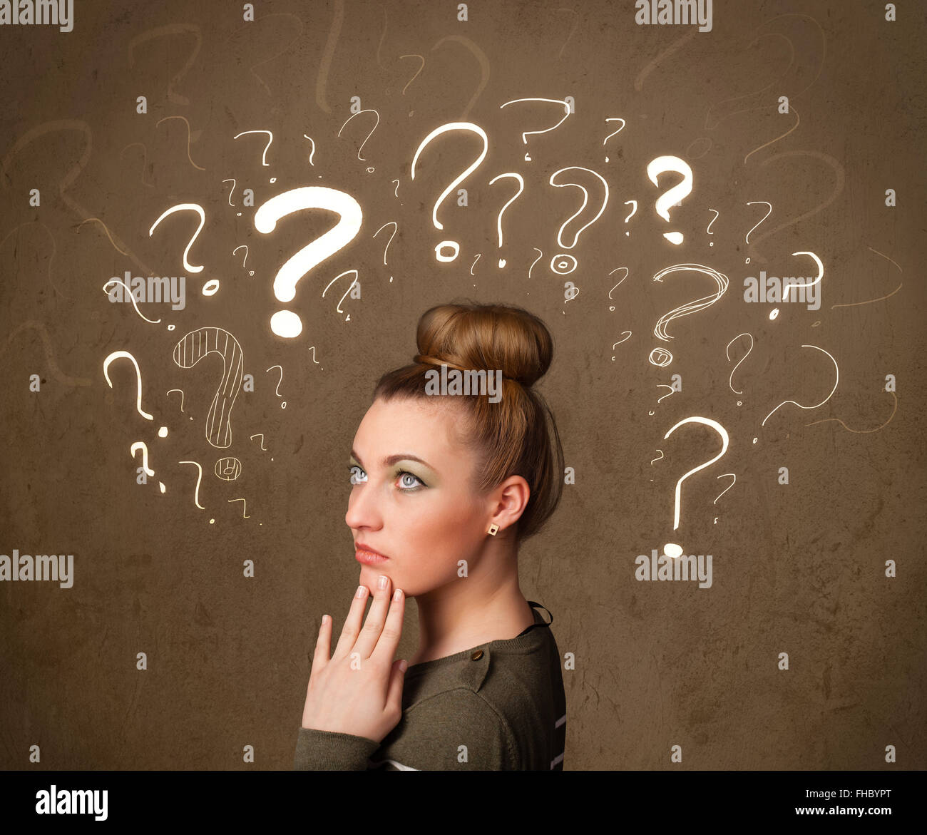 girl with question mark symbols around her head Stock Photo - Alamy