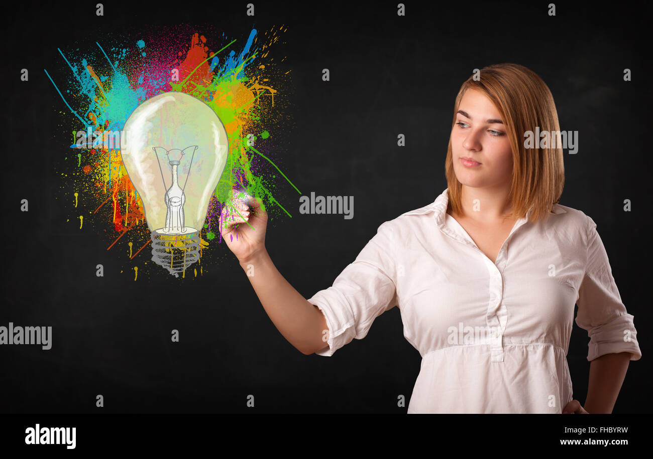 Young lady drawing a colorful light bulb with colorful splashes Stock ...
