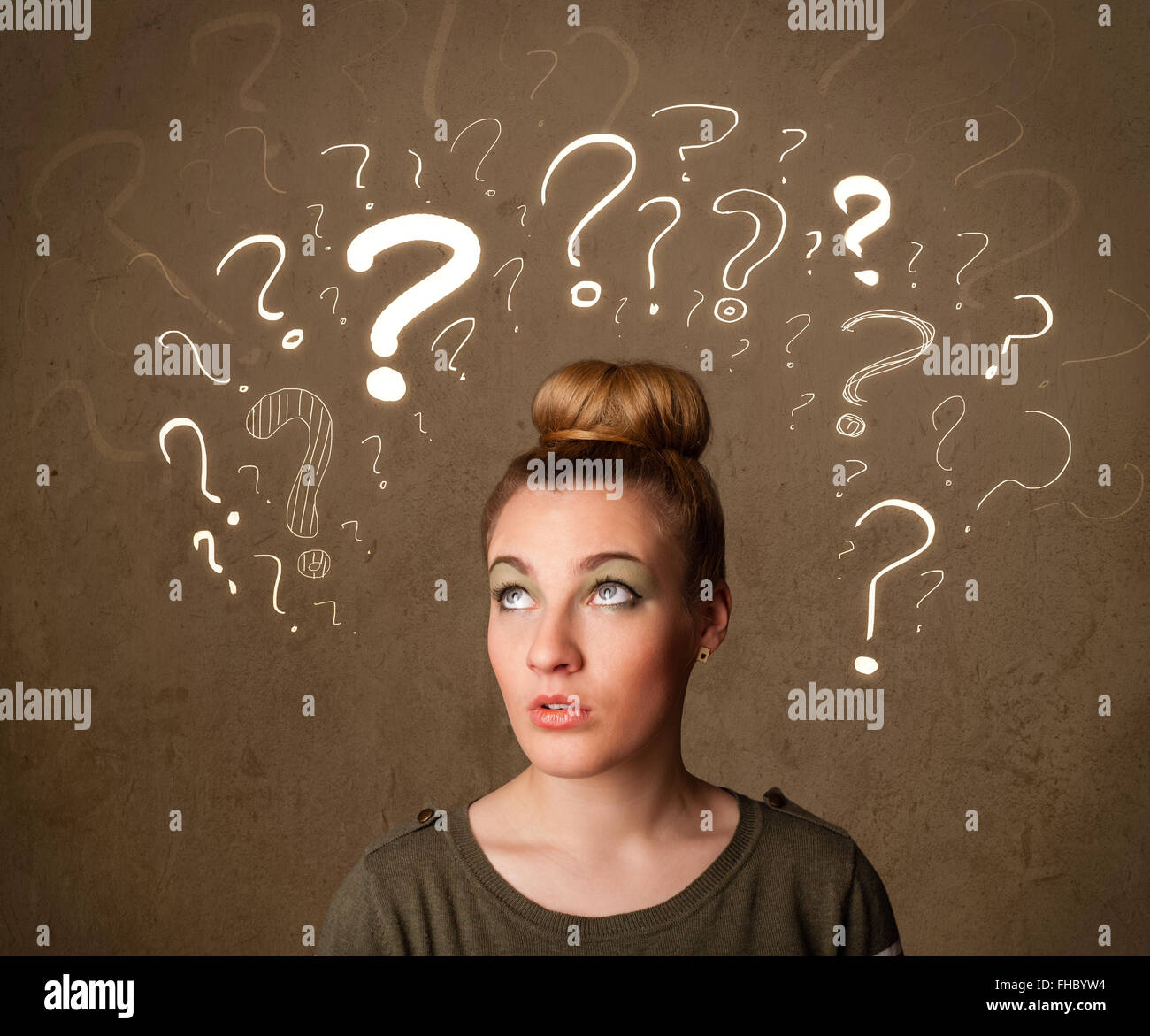 girl with question mark symbols around her head Stock Photo - Alamy