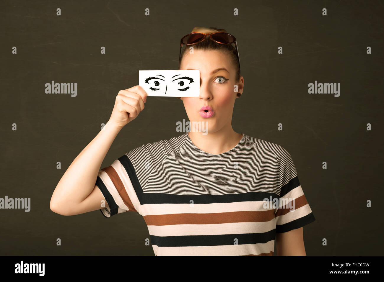 Silly youngster looking with hand drawn eye paper Stock Photo - Alamy
