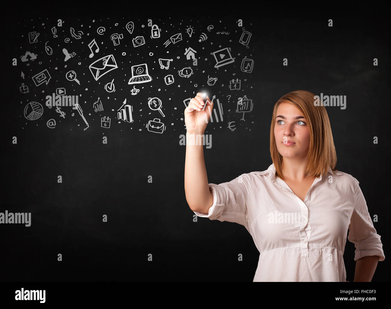 Young woman drawing and sketching icons and symbols Stock Photo - Alamy