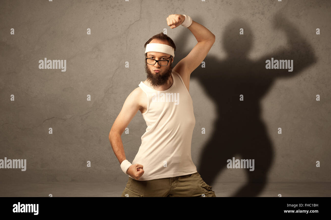Skinny man with musculous shadow Stock Photo - Alamy
