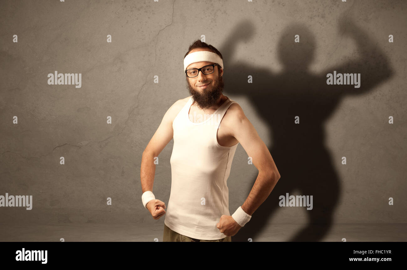 Skinny man with musculous shadow Stock Photo - Alamy