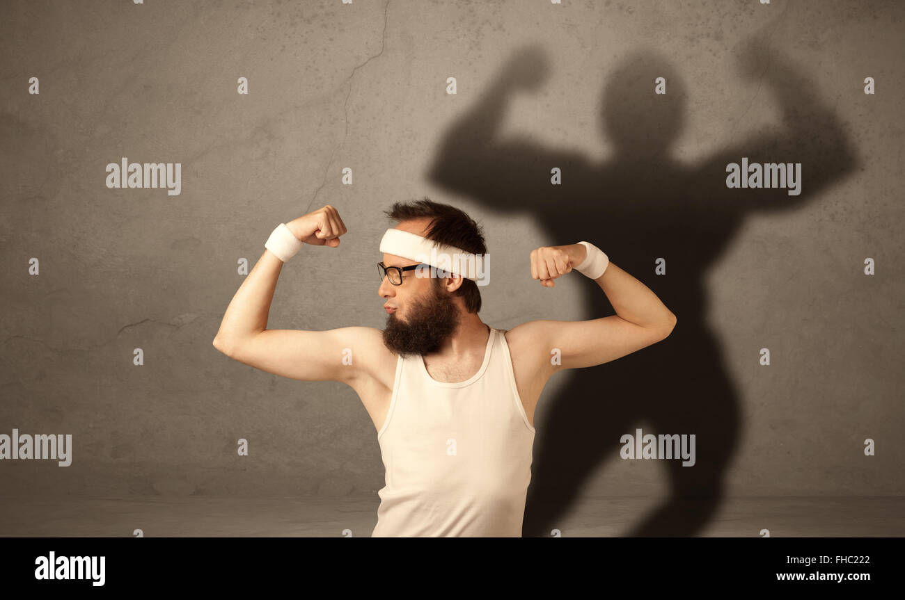 Skinny man with musculous shadow Stock Photo - Alamy