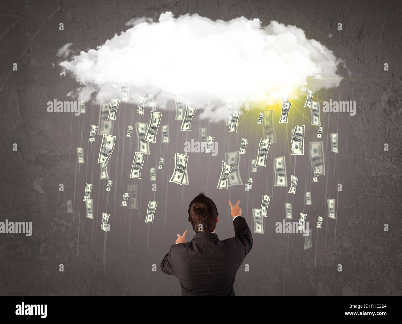 Business man in suit looking at cloud with falling money Stock Photo ...