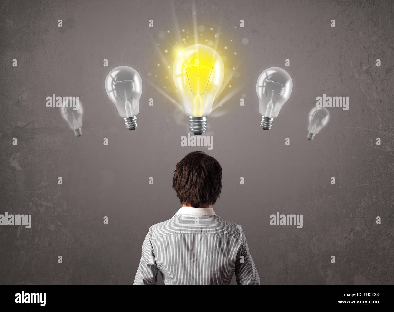 Business person having an idea light bulb concept Stock Photo - Alamy