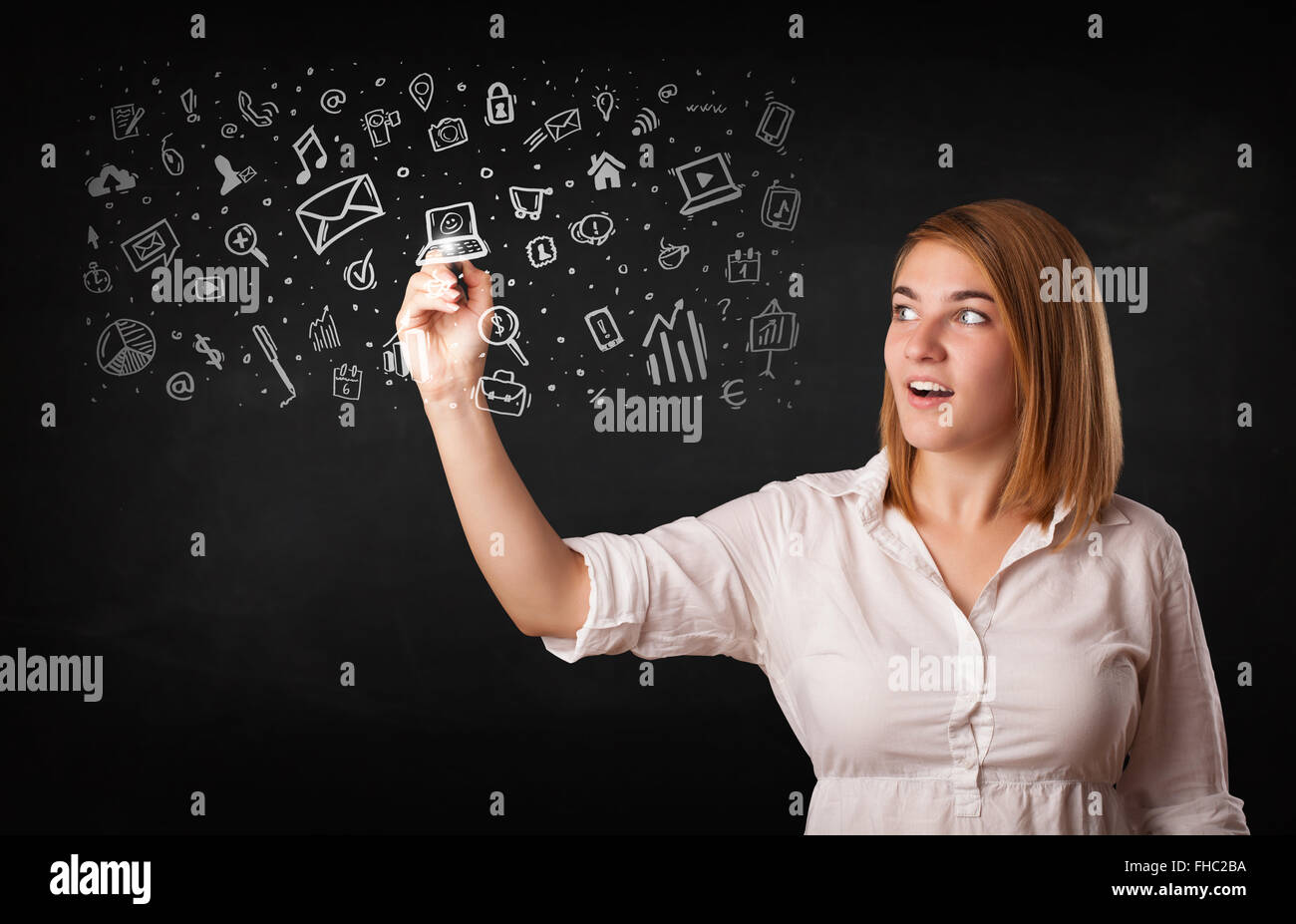 Young woman drawing and sketching icons and symbols Stock Photo - Alamy