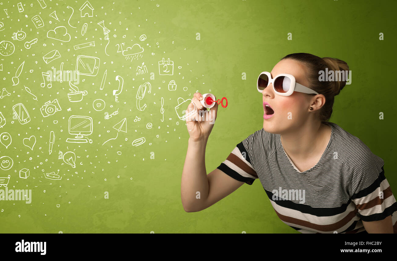 Cute girl blowing hand drawn media icons and symbols Stock Photo - Alamy