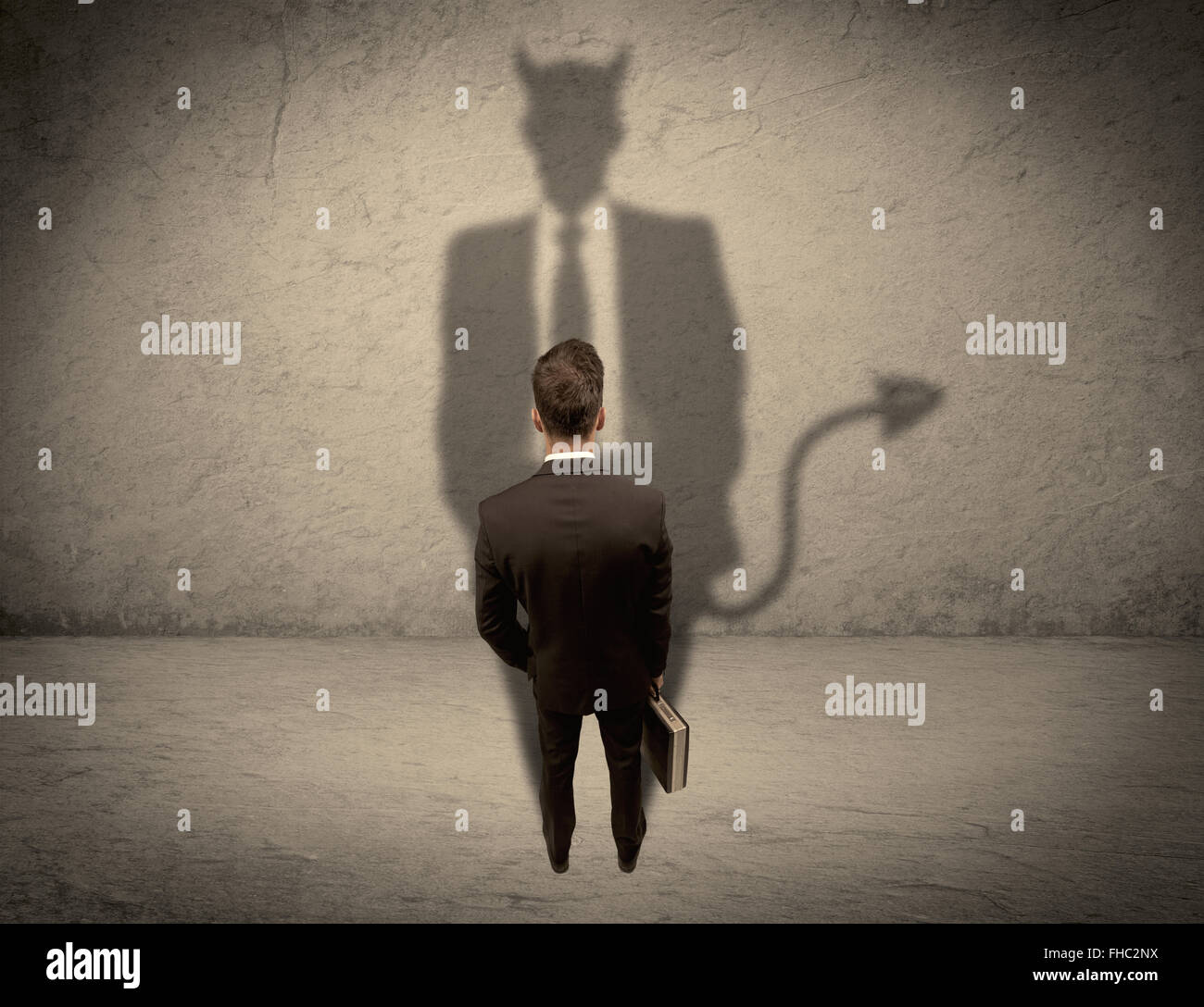 Salesman facing his own devil shadow Stock Photo - Alamy