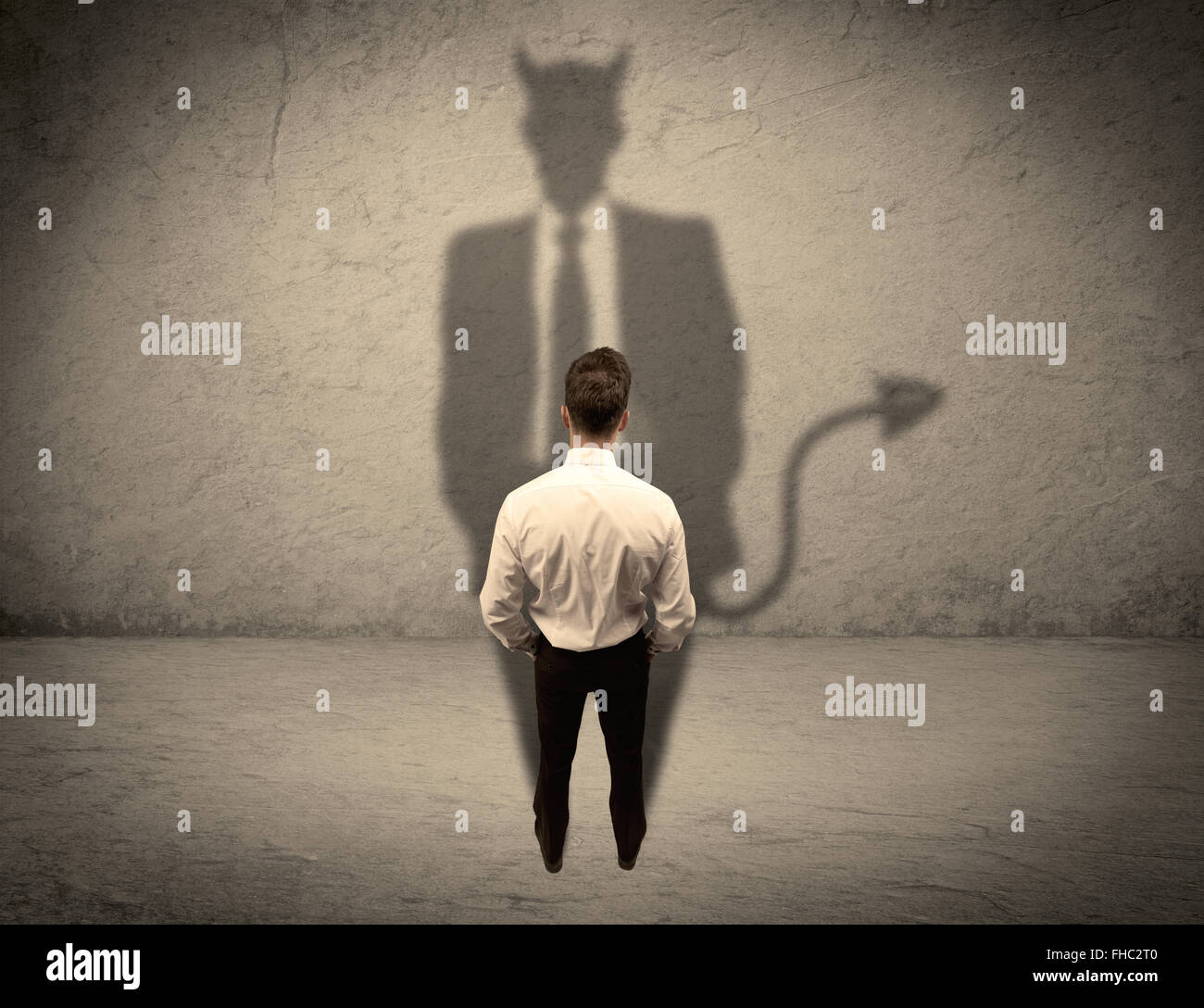 Salesman facing his own devil shadow Stock Photo - Alamy
