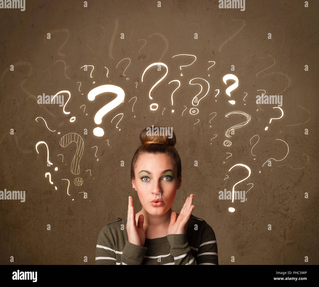 girl with question mark symbols around her head Stock Photo - Alamy