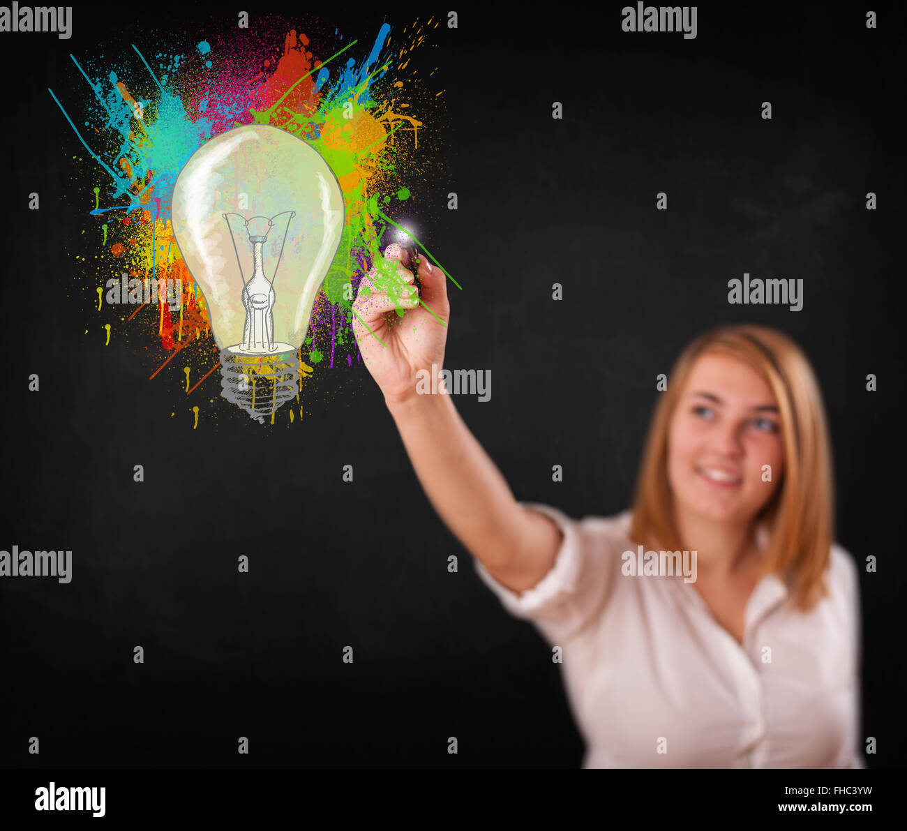Young lady drawing a colorful light bulb with colorful splashes Stock ...