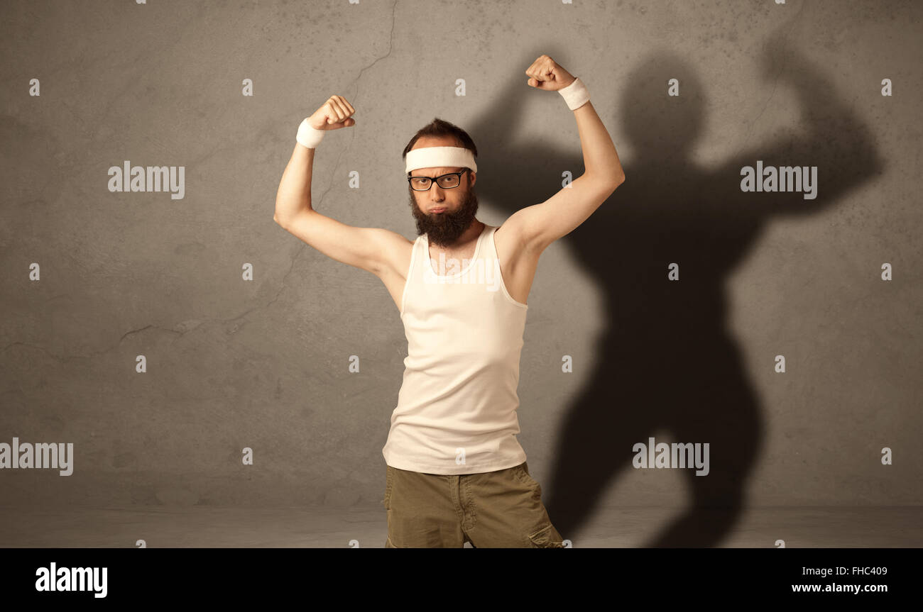 Skinny man with musculous shadow Stock Photo - Alamy